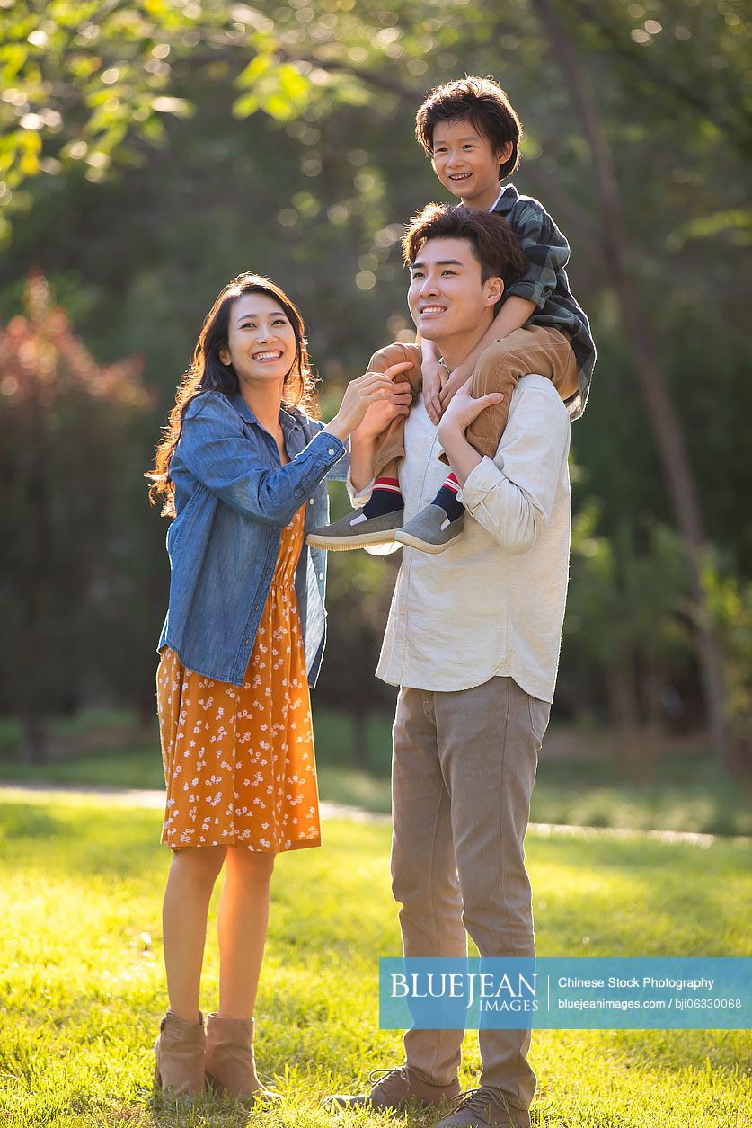 Happy young Chinese family having fun in park-High-res stock photo for ...