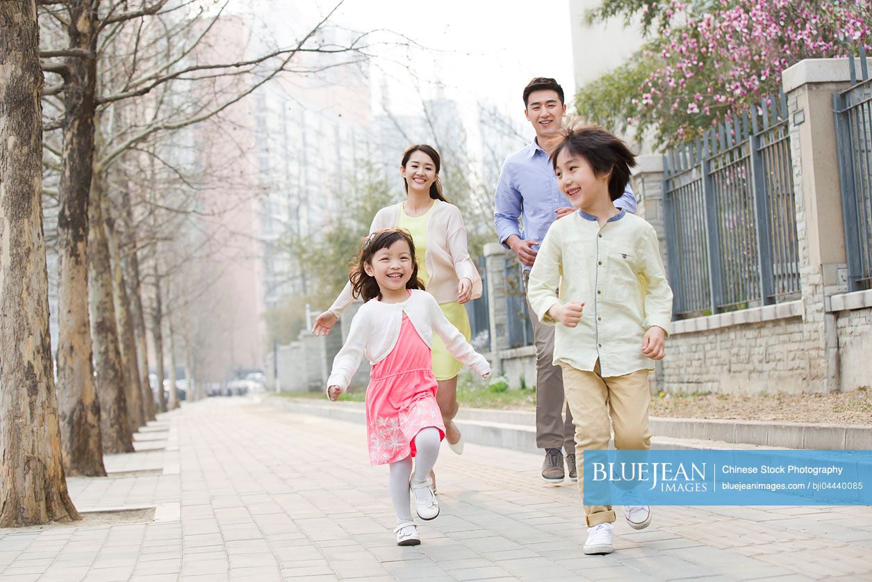 Happy young Chinese family running-High-res stock photo for download