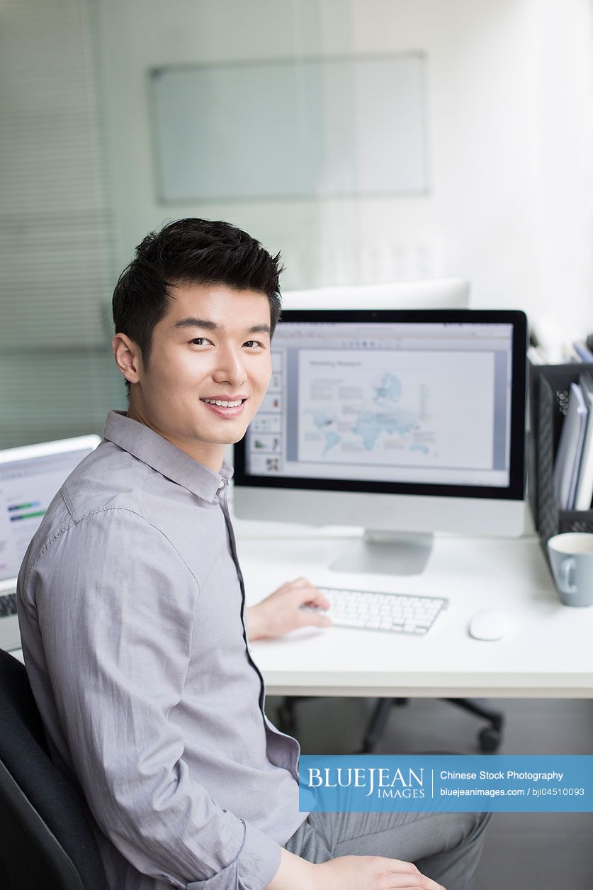 Young Chinese businessman using computer in office-High-res stock photo ...
