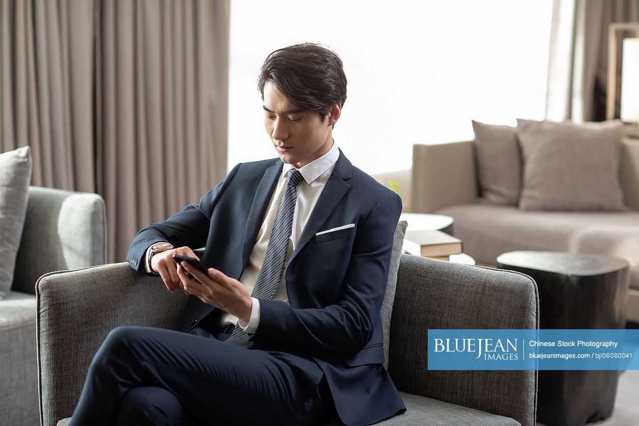 Young Chinese businessman waiting in airport lounge-High-res stock ...