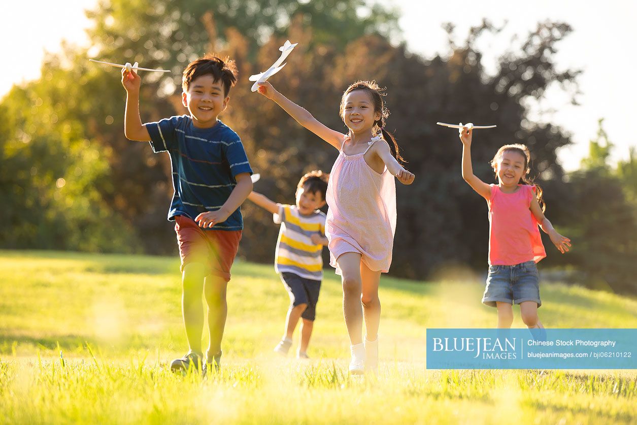 Happy Chinese children playing on meadow-High-res stock photo for download