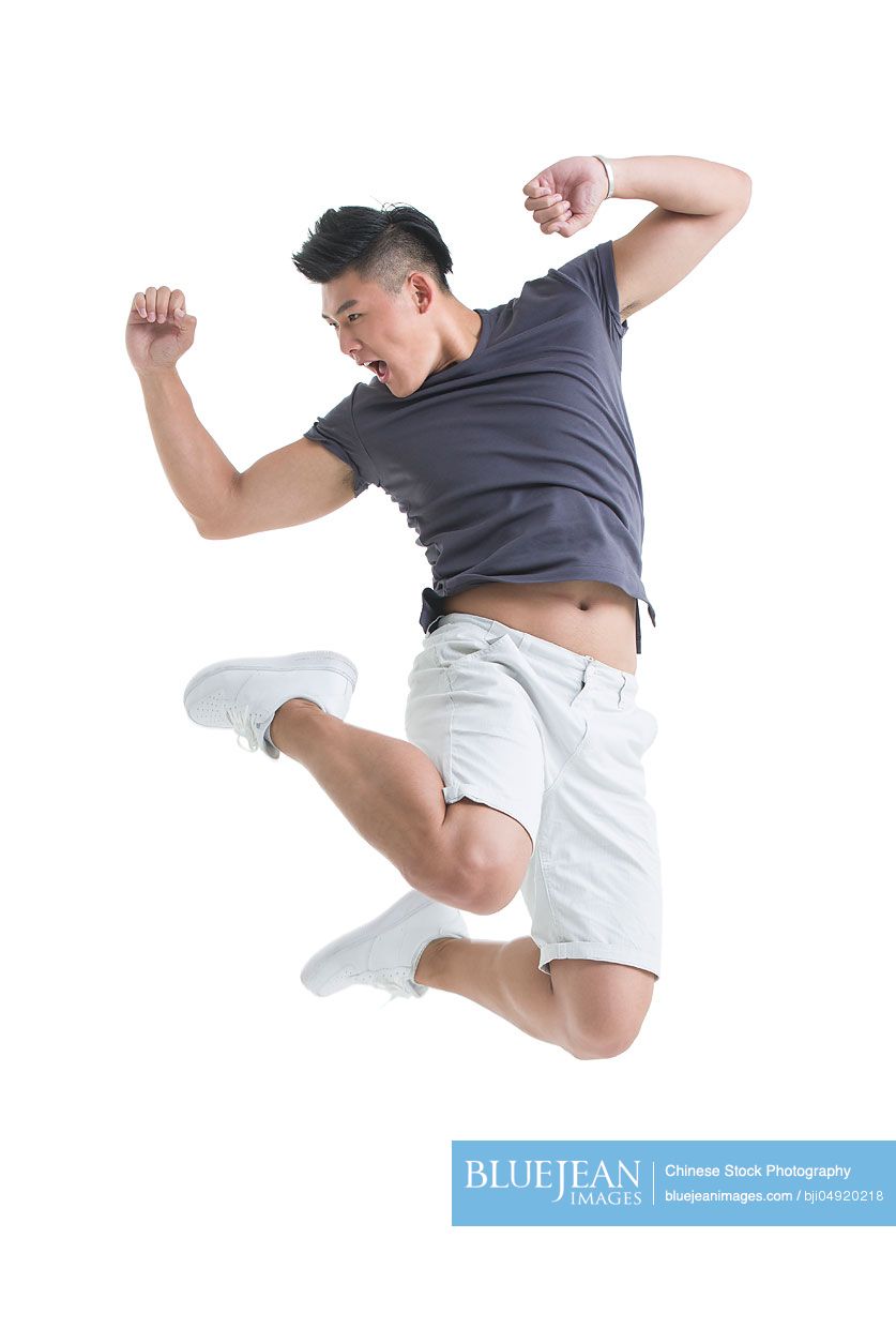 Happy young Chinese man jumping-High-res stock photo for download