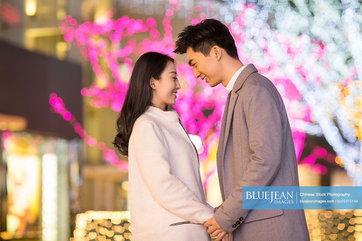 Cheerful young Chinese couple dating-High-res stock photo for download