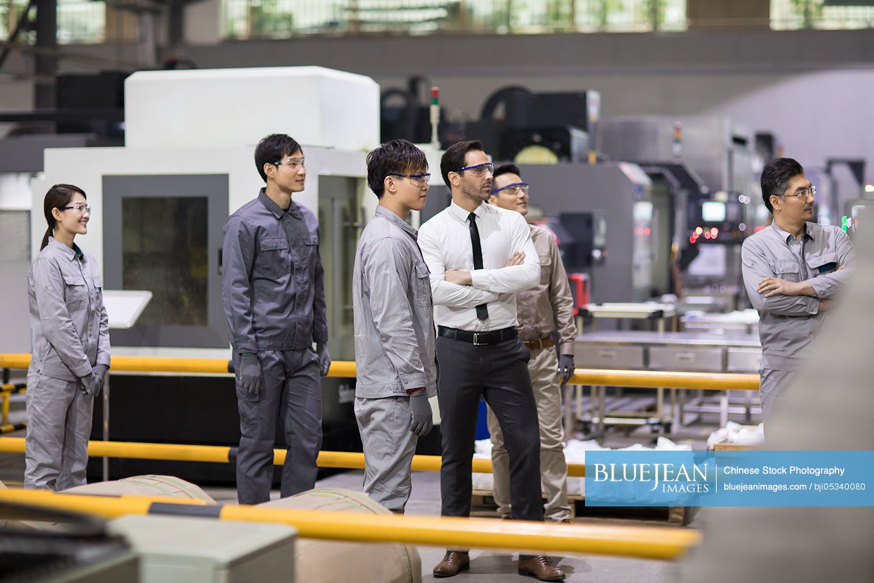 Confident businessman and engineering team in the factory-High-res ...