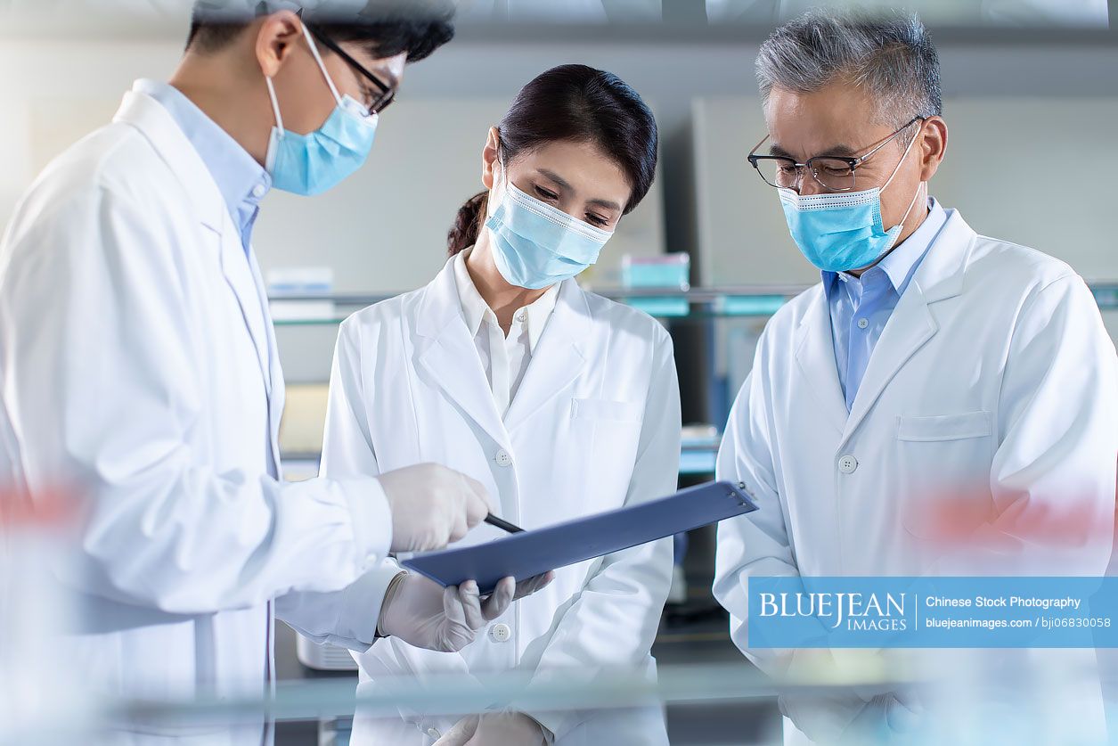 Three Chinese researchers discussing in laboratory-High-res stock photo ...