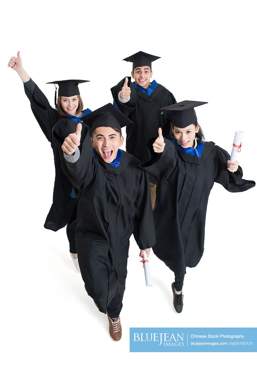 Happy college graduates in graduation gowns doing thumbs up-High-res ...