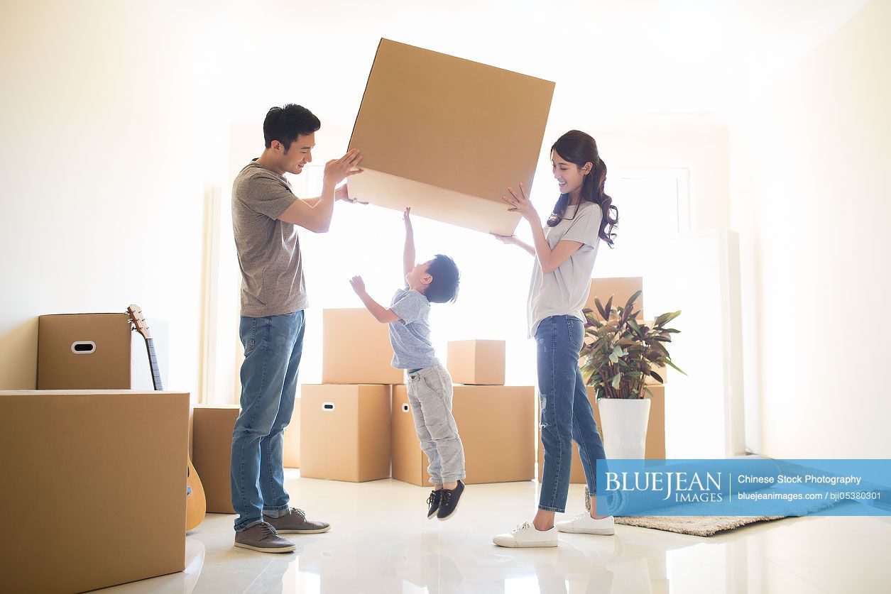 Happy young Chinese family moving to a new house-High-res stock photo ...
