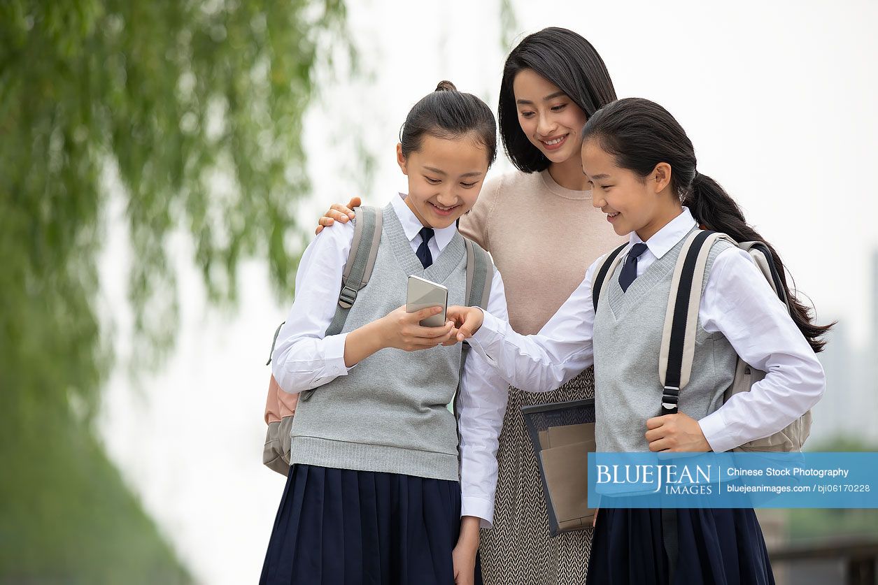 Chinese students showing teacher smartphone-High-res stock photo for ...