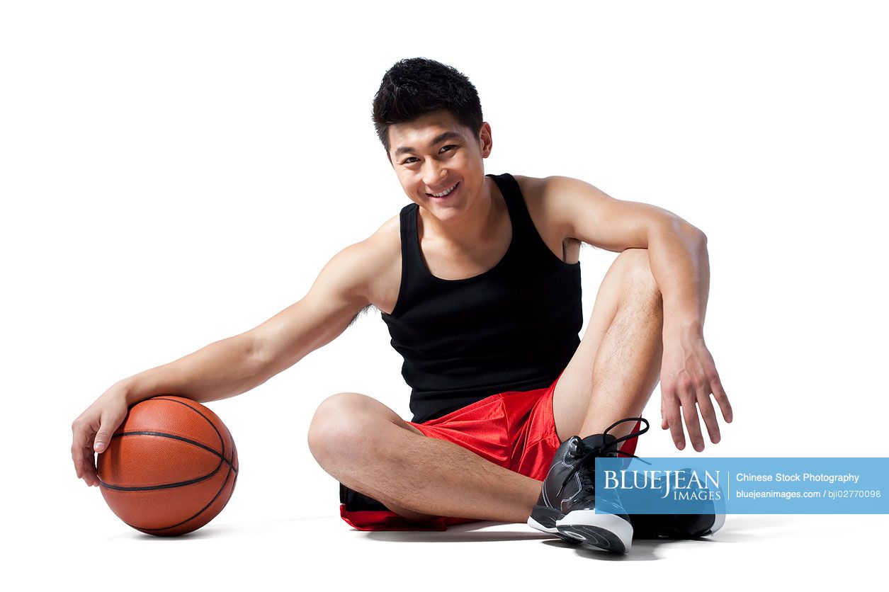 Chinese man sitting on the floor with basketball-High-res stock photo ...