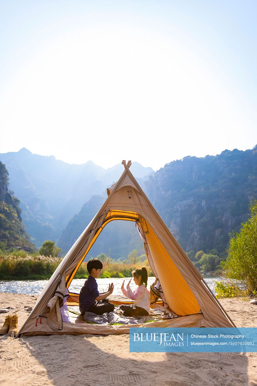 Cute Chinese Children relaxing in tent-High-res stock photo for download