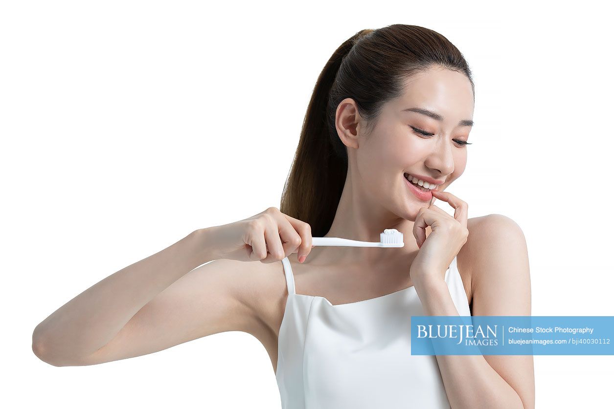 Beautiful young Chinese woman brushing teeth-High-res stock photo for ...