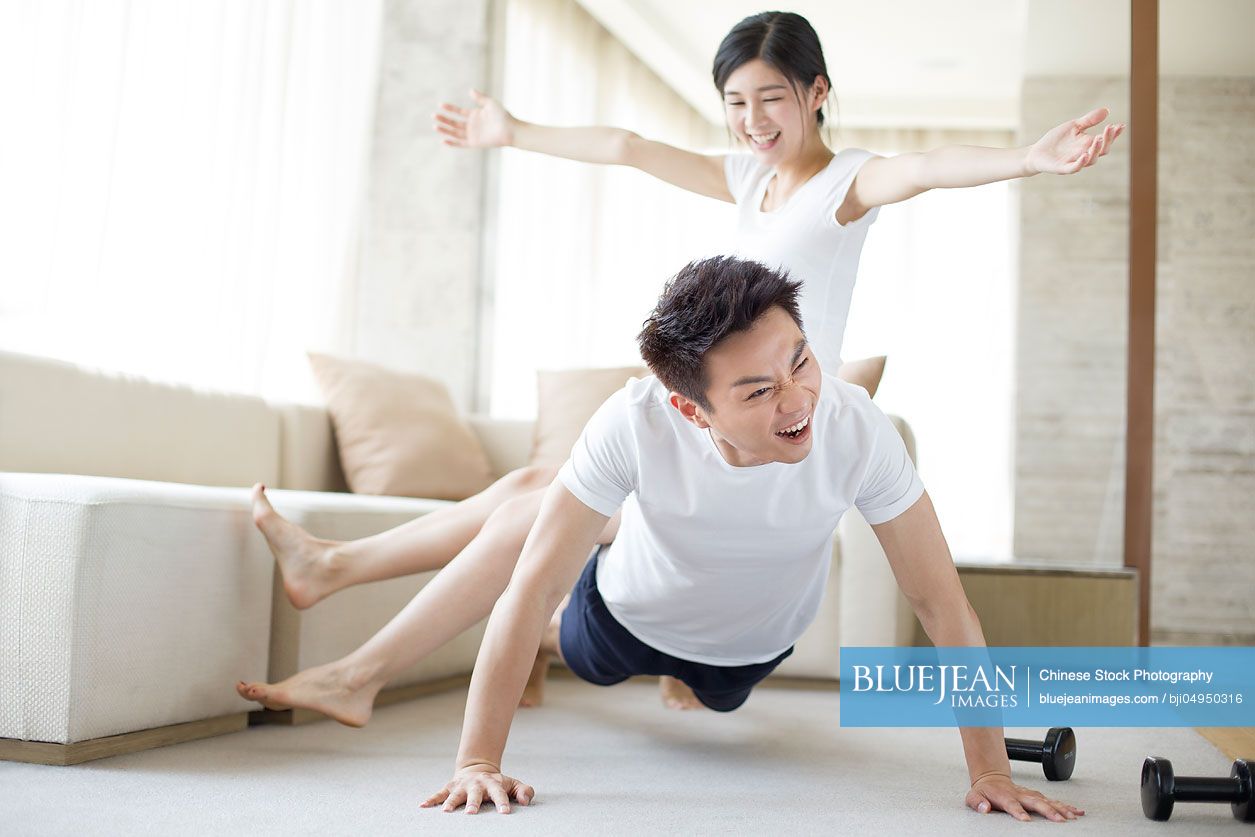 Young Chinese couple exercising at home-High-res stock photo for download