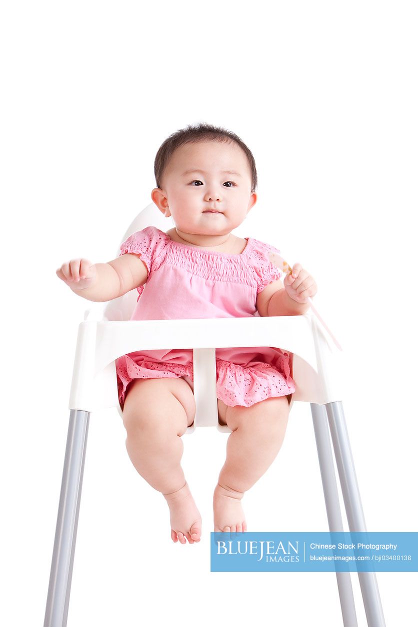 Lovely Chinese baby girl on baby high chair-High-res stock photo for ...