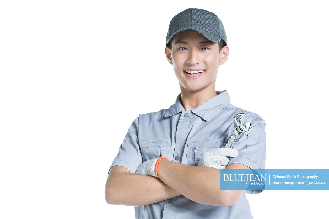 Chinese repairman holding a spanner-High-res stock photo for download