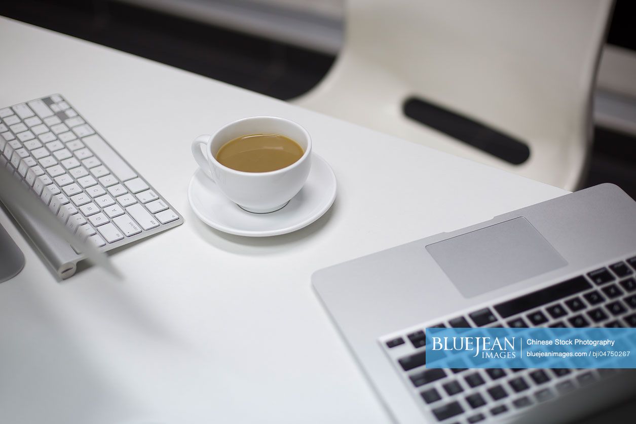 A cup of coffee and a laptop in office-High-res stock photo for download