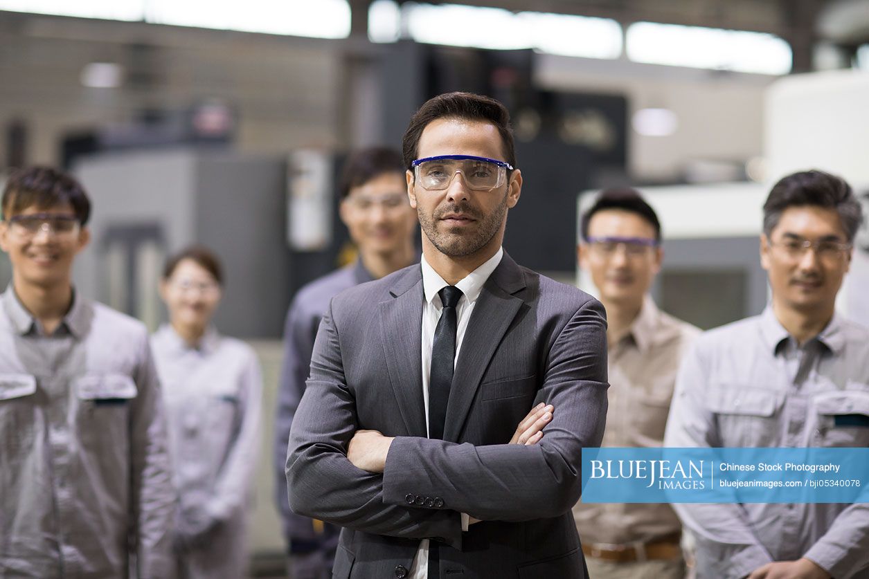 Confident businessman and engineering team in the factory-High-res ...