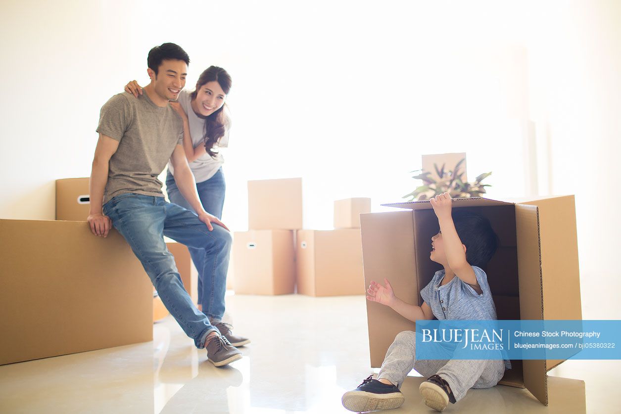 Happy young Chinese family moving to a new house-High-res stock photo ...