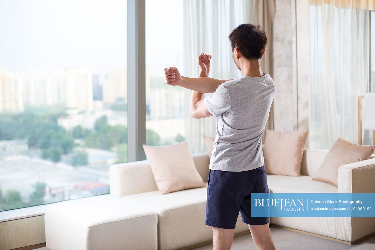 Young Chinese man exercising at home-High-res stock photo for download