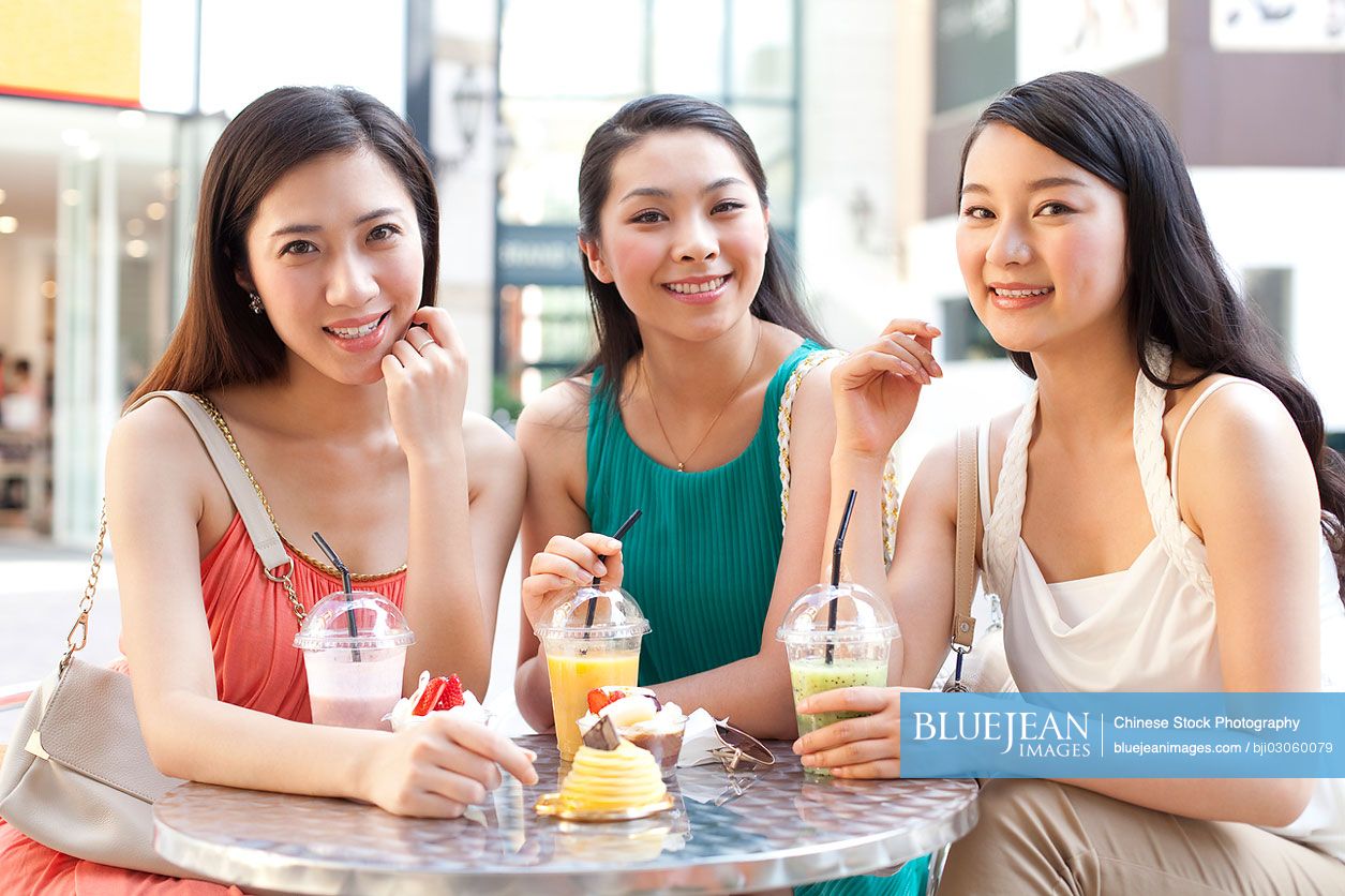 Best female Chinese friends sitting at sidewalk café-High-res stock ...