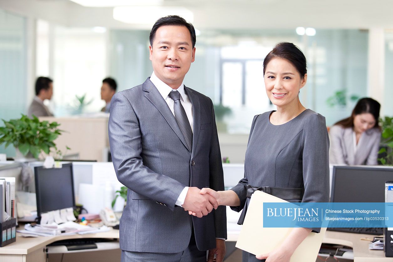 Cheerful Chinese business partners shaking hands-High-res stock photo ...