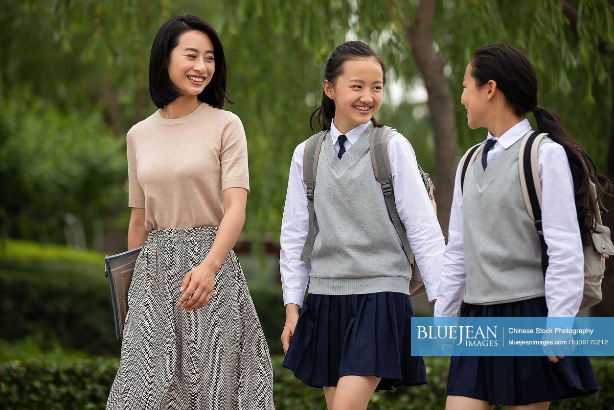 Chinese teacher talking with student on campus-High-res stock photo for ...