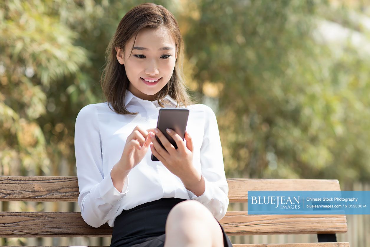 Young Chinese businesswoman using smart phone-High-res stock photo for ...