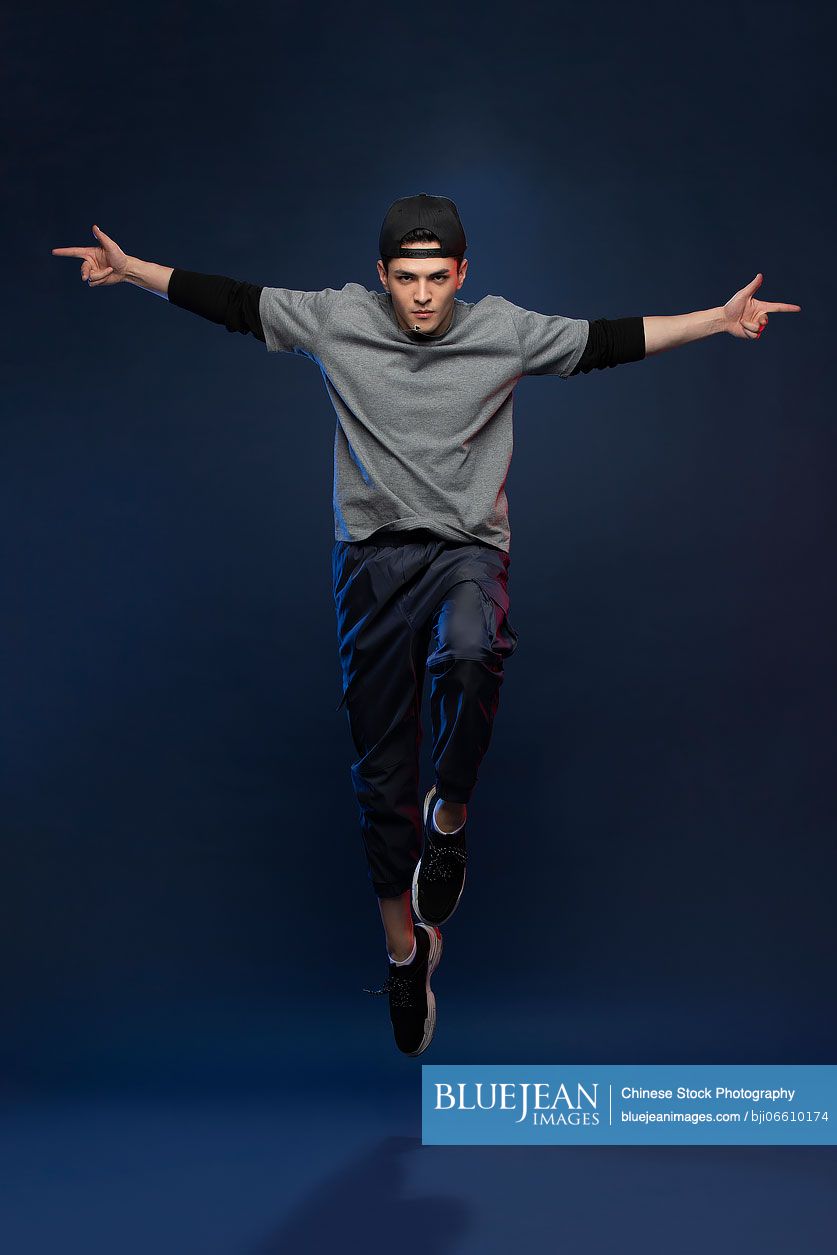 Studio shot of fashionable young Chinese man dancing-High-res stock ...