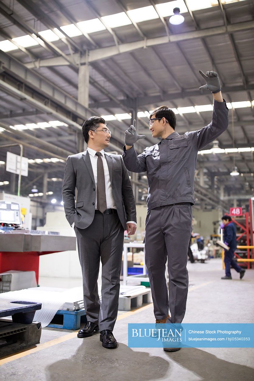 Chinese businessman and engineer talking in the factory-High-res stock ...