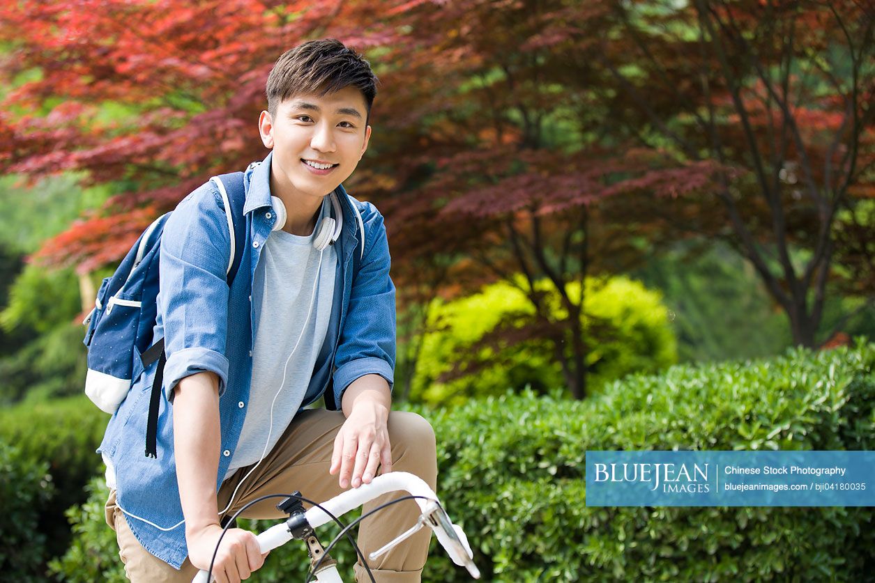 Male Chinese college student with bicycle-High-res stock photo for download