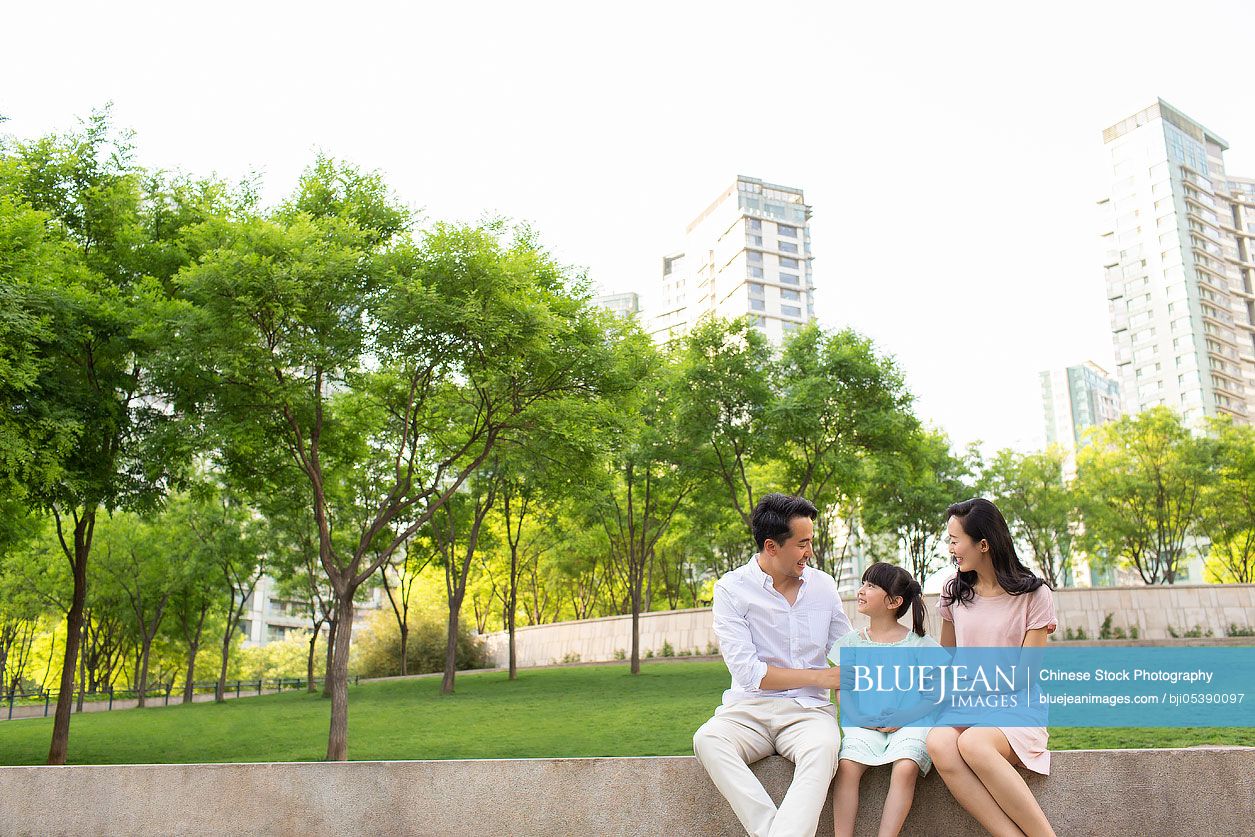 Happy young Chinese family relaxing in park-High-res stock photo for ...