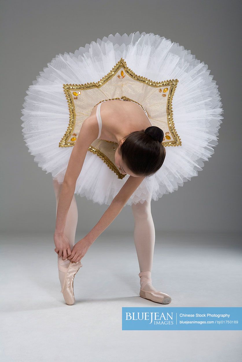 Chinese ballerina tying the straps on her ballet slippers-High-res ...