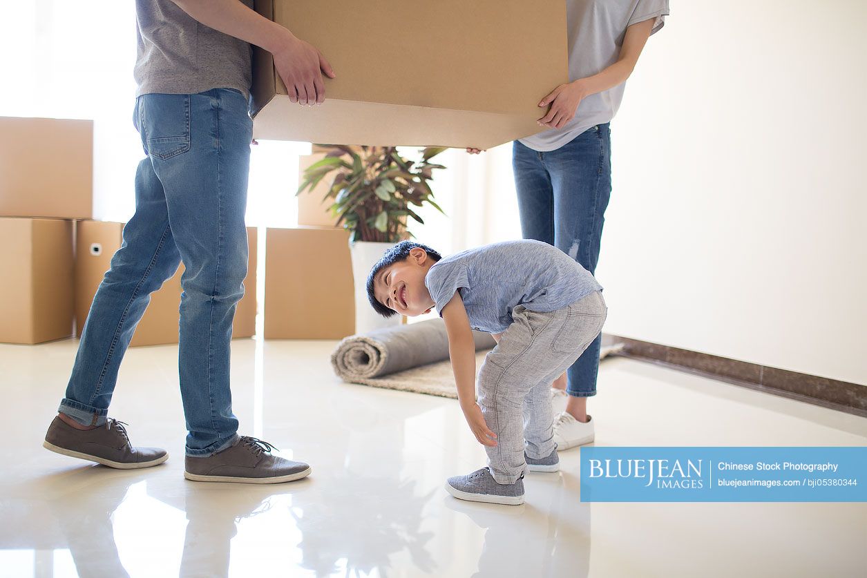 Happy young Chinese family moving to a new house-High-res stock photo ...