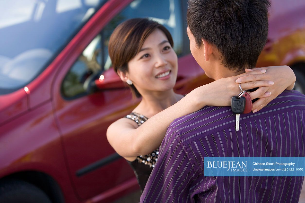 Young Chinese couple buys a new car-High-res stock photo for download