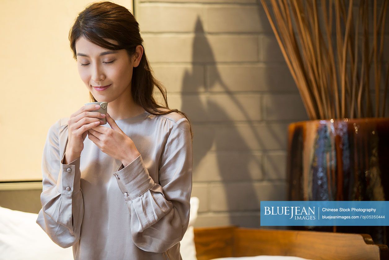 Elegant Chinese young woman drinking tea-High-res stock photo for download