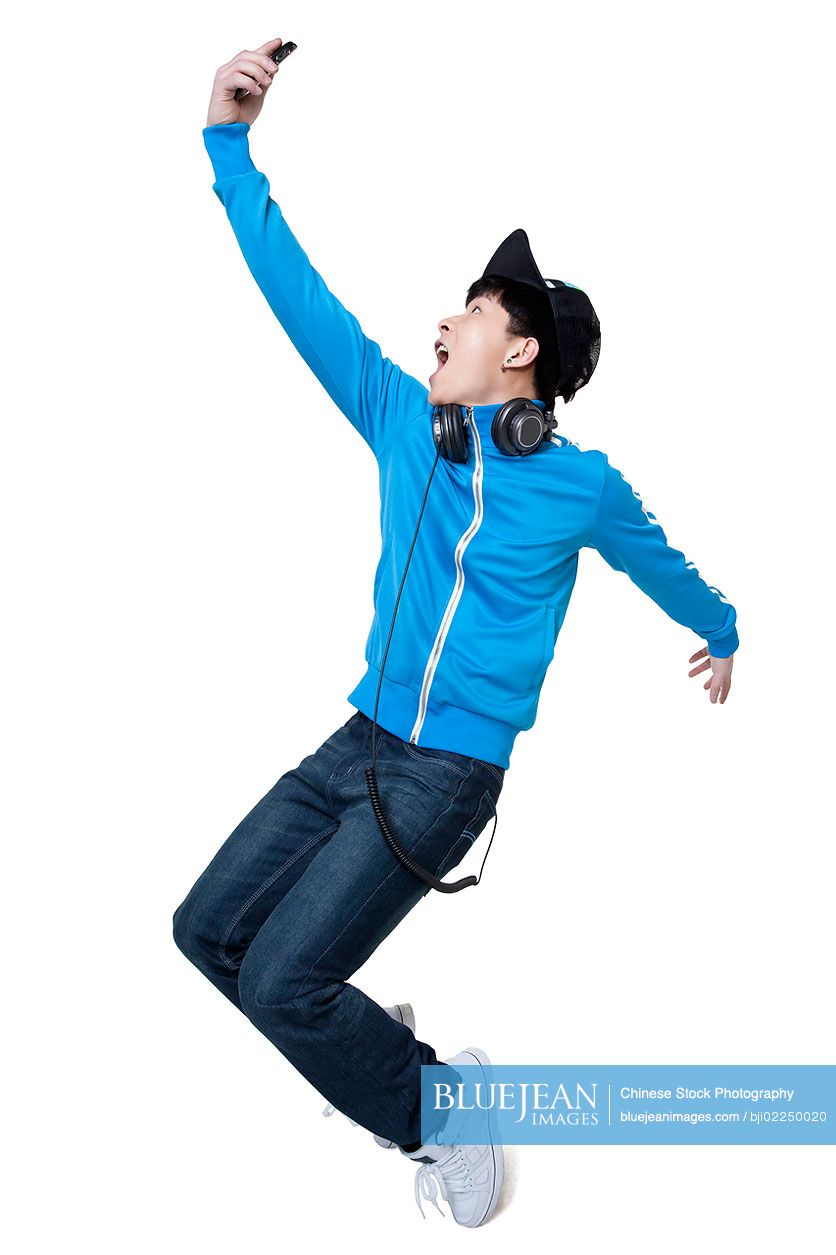 Chinese man dancing while holding up his phone-High-res stock photo for ...