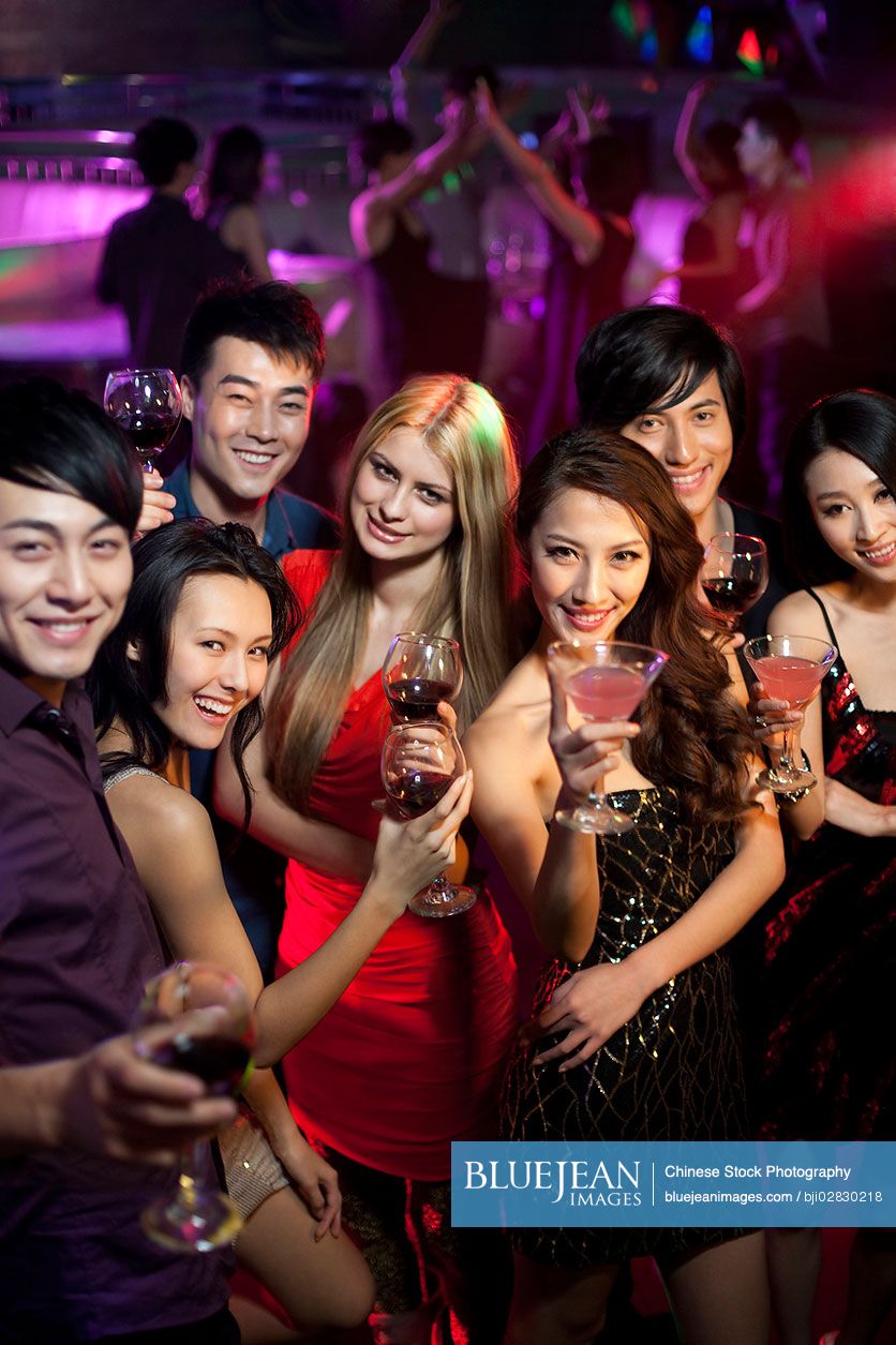 Stylish young Chinese drinking in bar-High-res stock photo for download