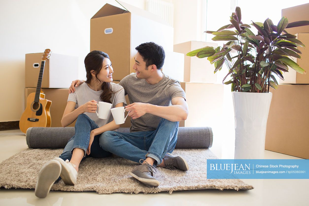 Happy young Chinese couple moving to a new house-High-res stock photo ...
