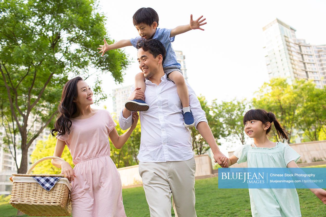 Happy young Chinese family having picnic in park-High-res stock photo ...