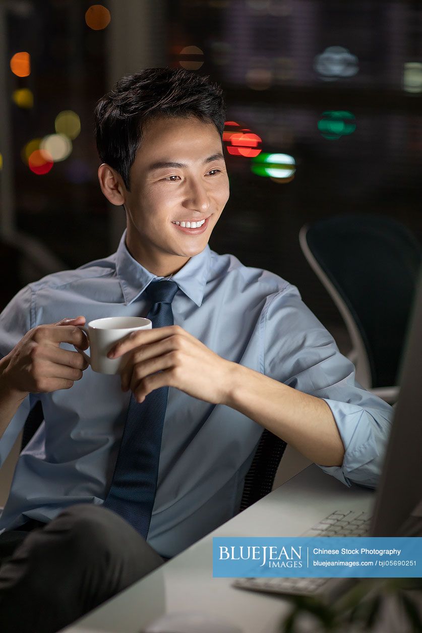 Young Chinese businessman working late in office-High-res stock photo ...