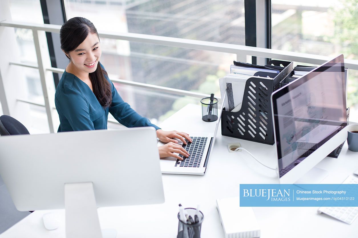 Young Chinese businesswoman working in office-High-res stock photo for ...
