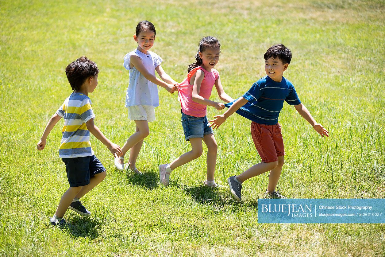 Happy Chinese children playing games on meadow-High-res stock photo for ...