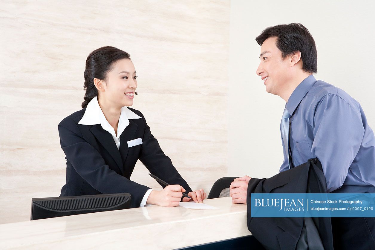 Chinese Businessman Smiling At Receptionist-High-res stock photo for ...
