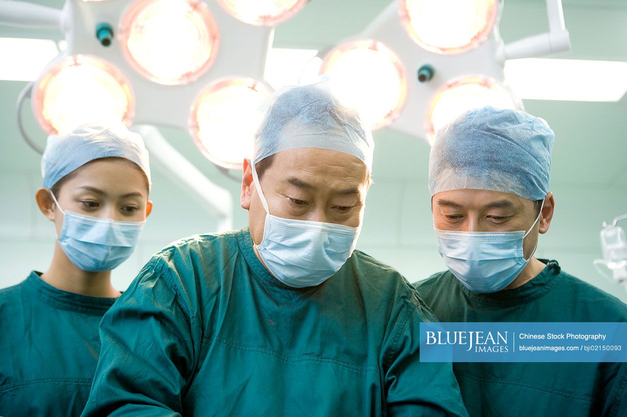 Three Chinese surgeons focused on an operation-High-res stock photo for ...