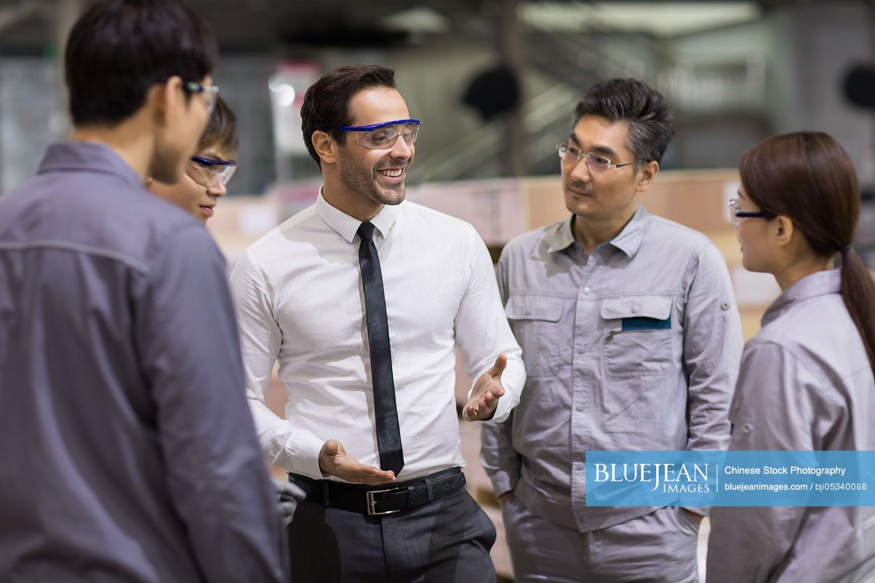 Businessman and engineers talking in the factory-High-res stock photo ...