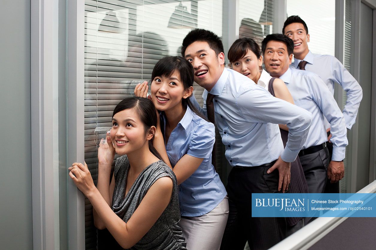 Chinese colleagues holding glasses against the wall-High-res stock ...