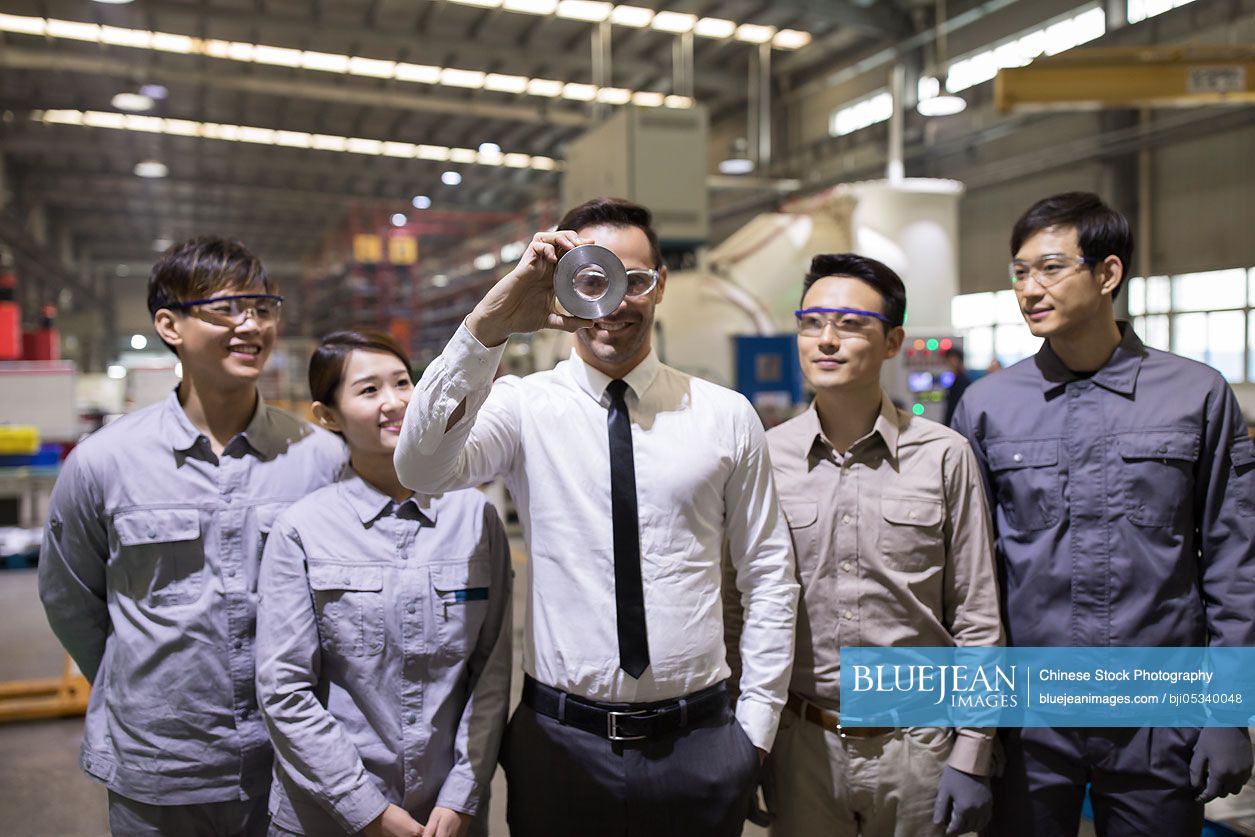Confident businessman and engineering team in the factory-High-res ...