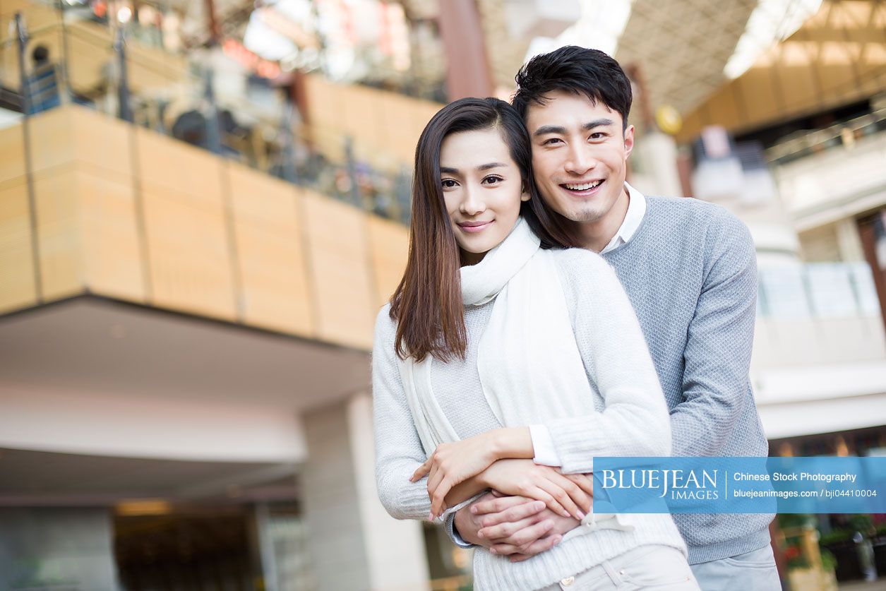 Young Chinese couple embracing in shopping mall-High-res stock photo ...