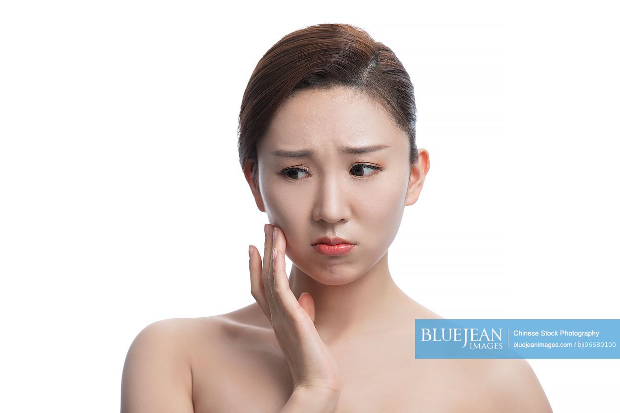 Beautiful young Chinese woman frowning-High-res stock photo for download