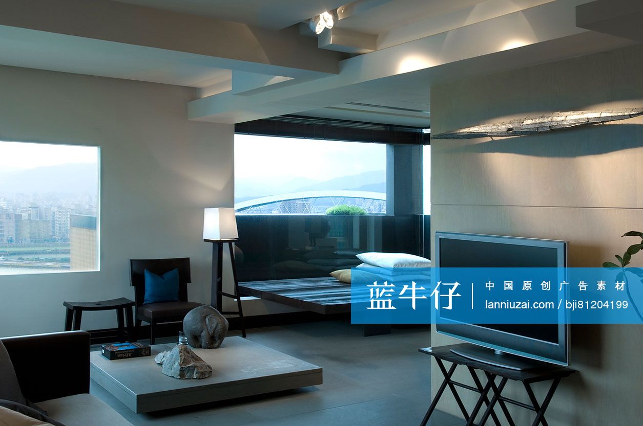 View of a contemporary living room with seating furniture; windows and ...