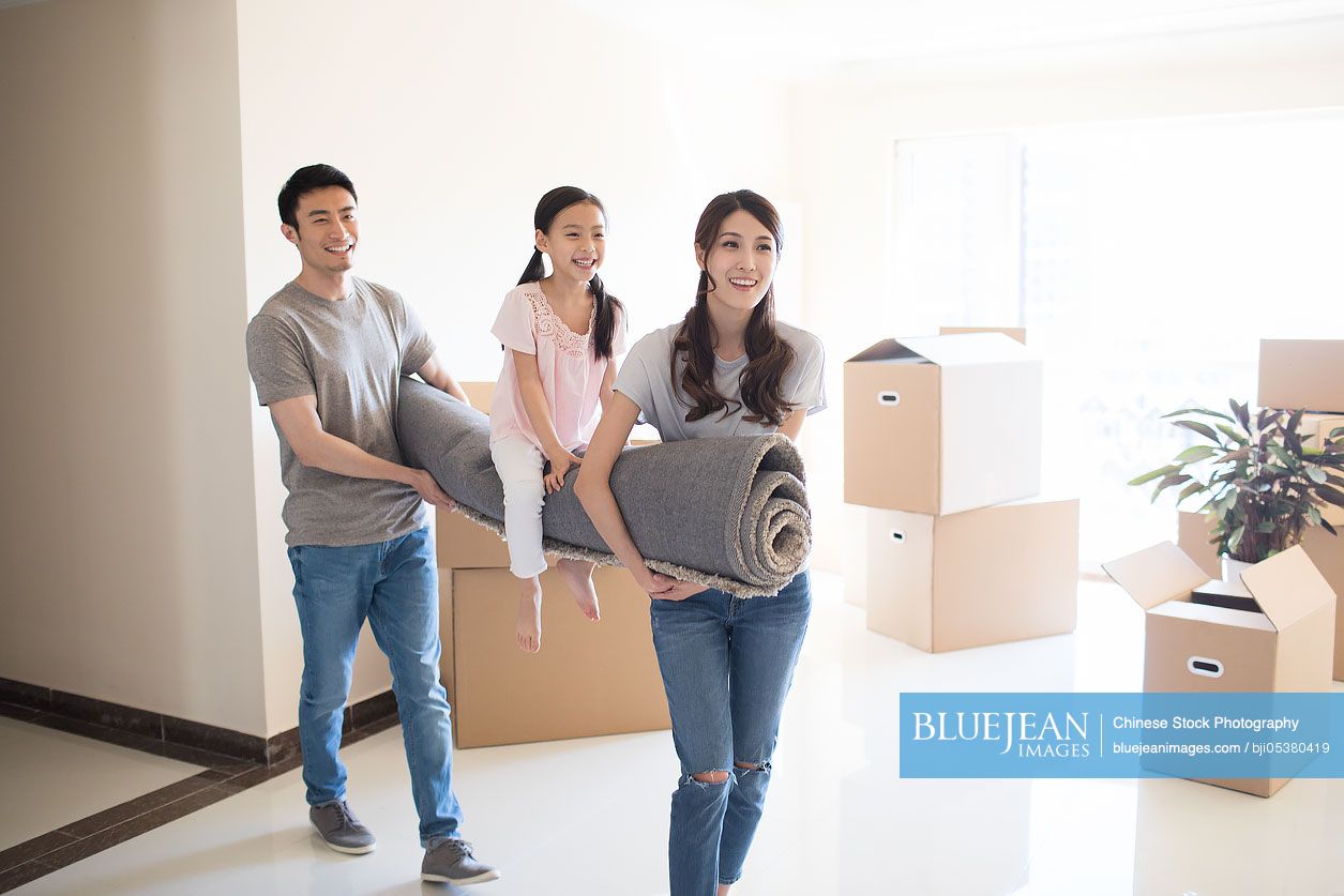 Happy young Chinese family moving to a new house-High-res stock photo ...